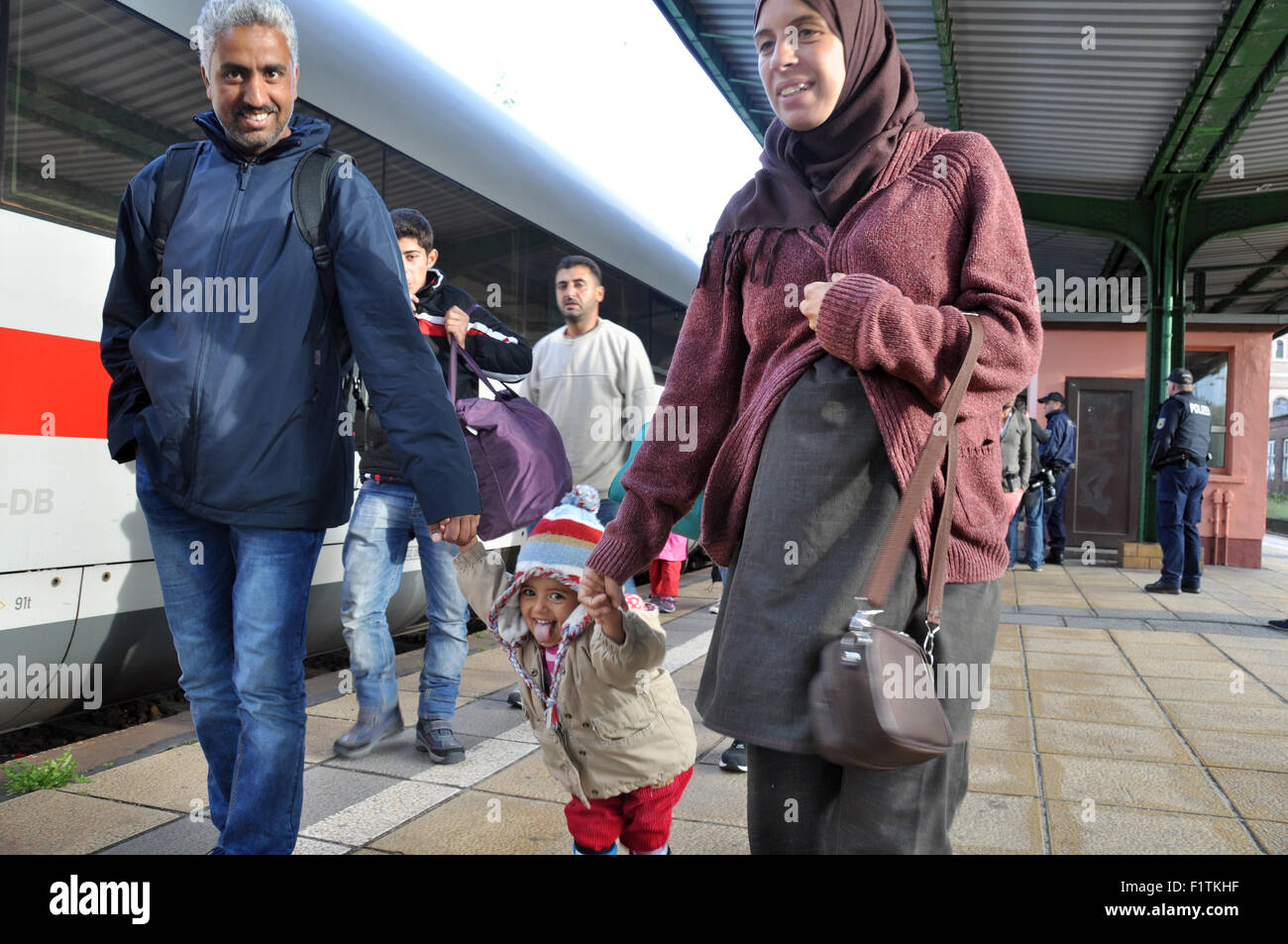 Eisenhuettenstadt, Germany. 07th Sep, 2015. A family with a child walks ...