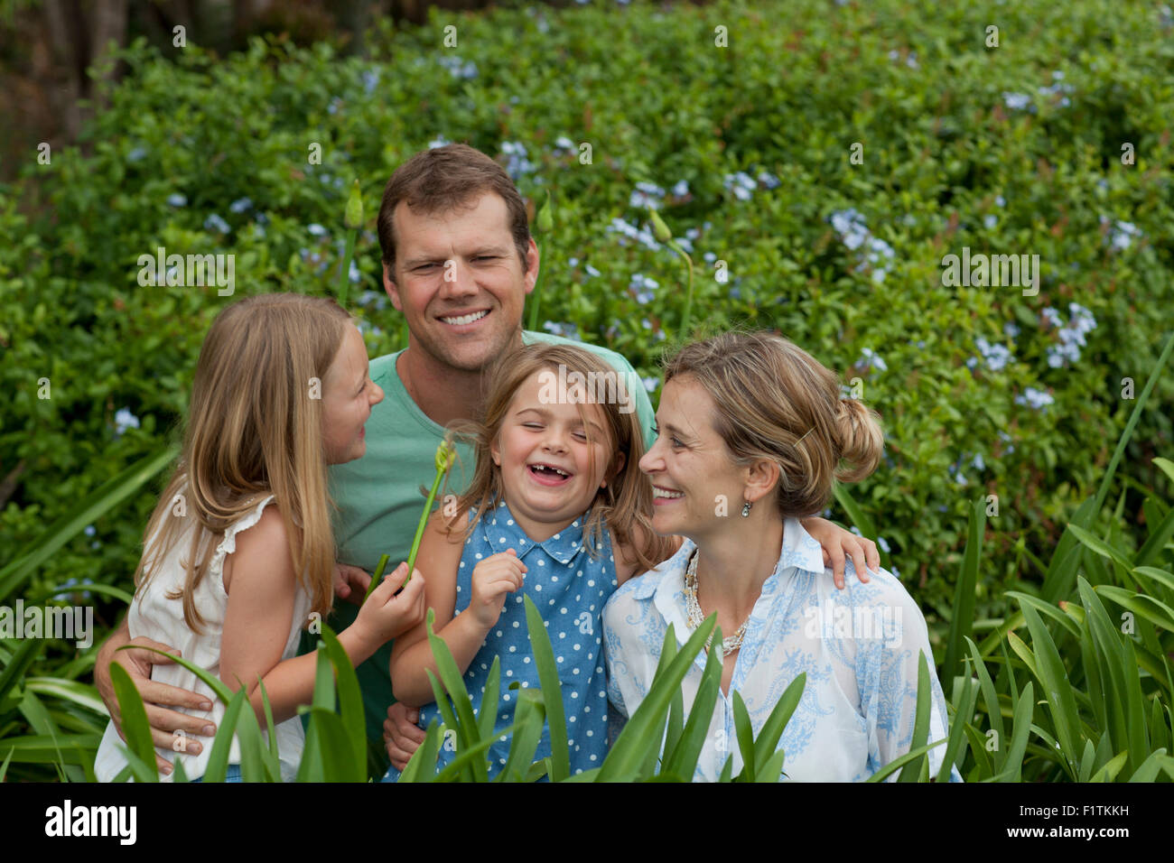 Portrait four happy family members hi-res stock photography and images ...