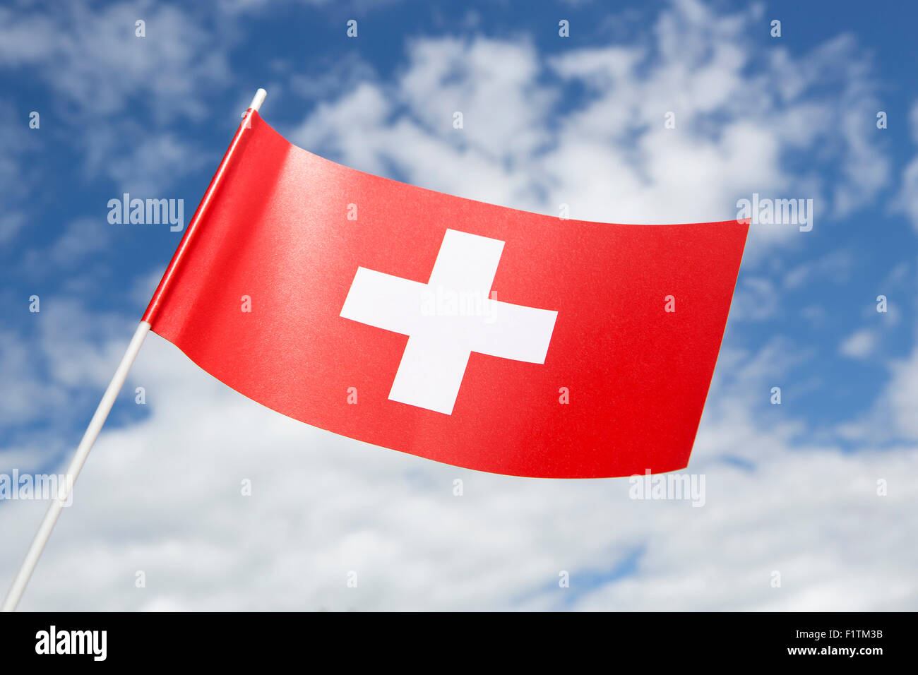 Switzerland flag in front of a blue sky Stock Photo - Alamy