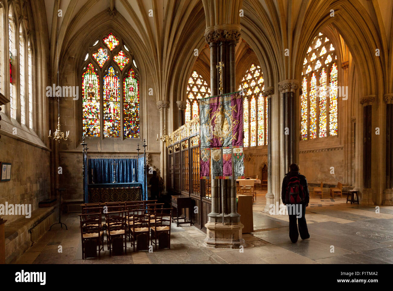 people in the interior of the medieval 12th century Wells Cathedral ...