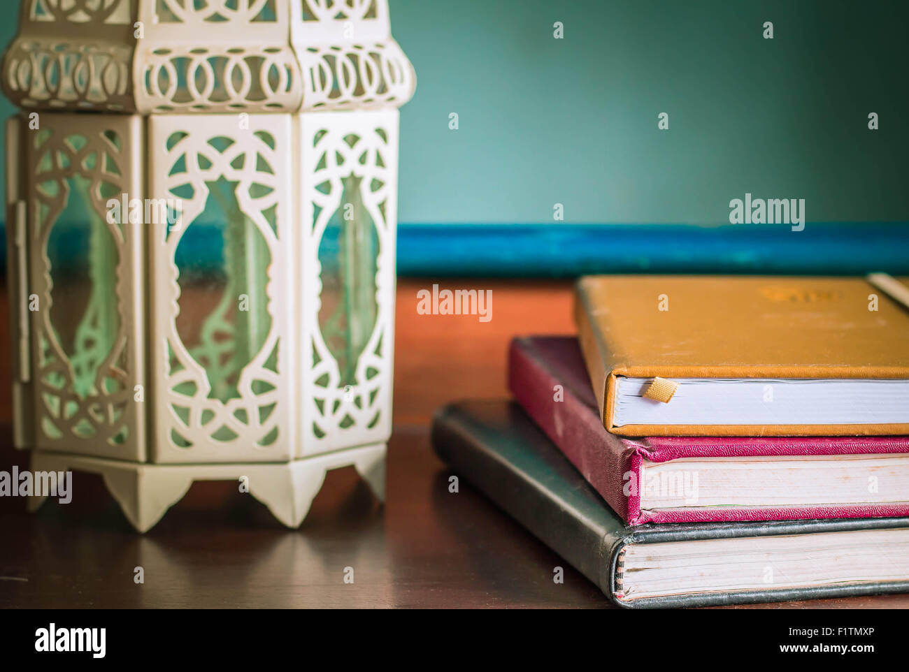 Book stackable and old lamp on the table Stock Photo - Alamy