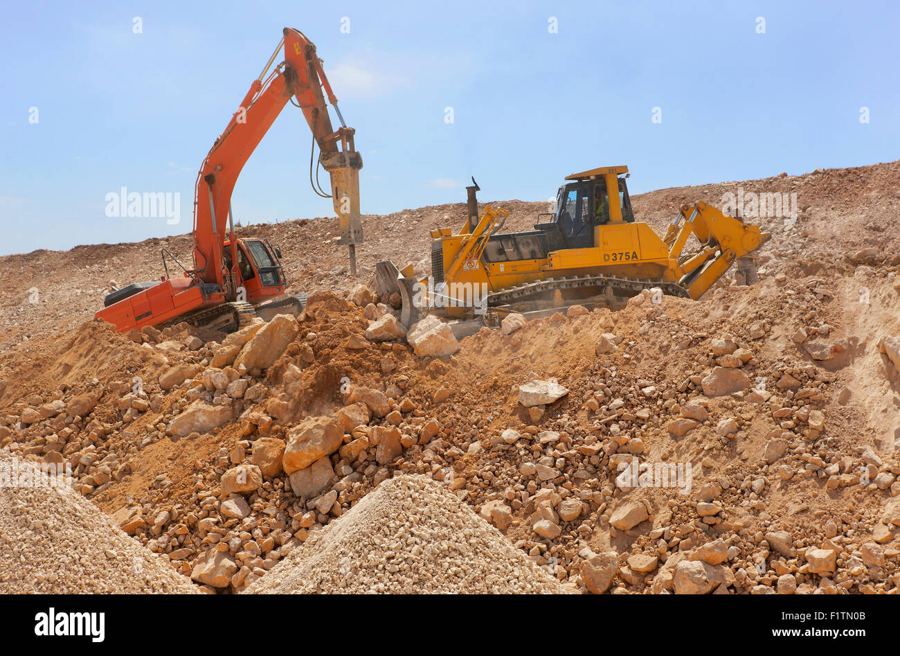 Loader machines in construction site loading soil Stock Photo - Alamy