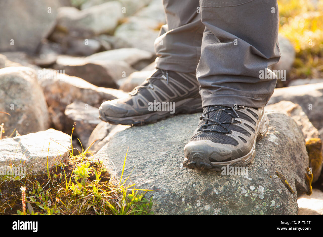 hiker standing on rocks Stock Photo - Alamy