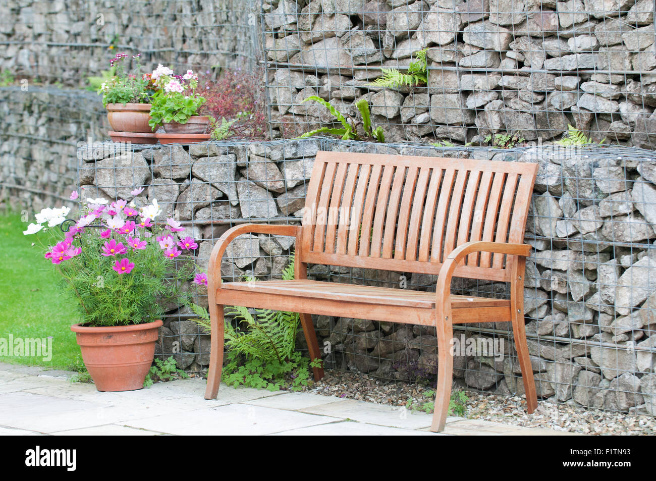 Garden bench on a patio Stock Photo - Alamy
