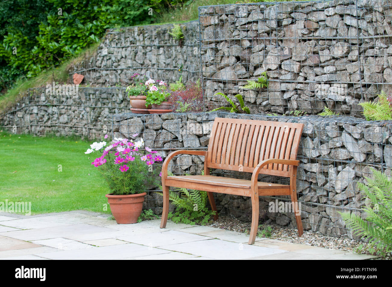 Garden bench on a patio Stock Photo - Alamy