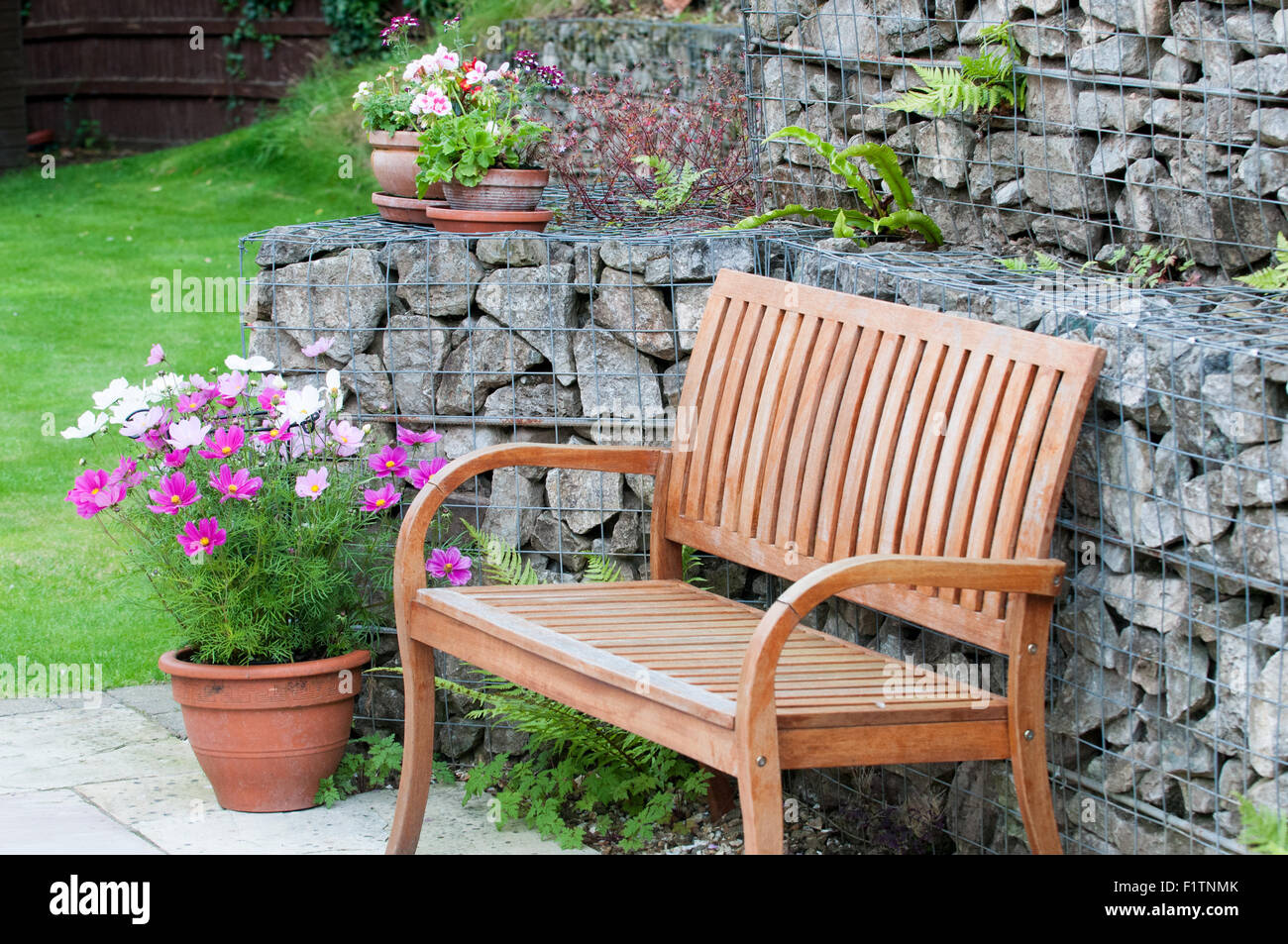 Garden bench on a patio Stock Photo - Alamy