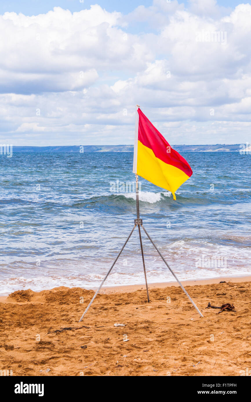Lifeguards swimming flag at Outer Hope Cove Beach in Devon, England ...