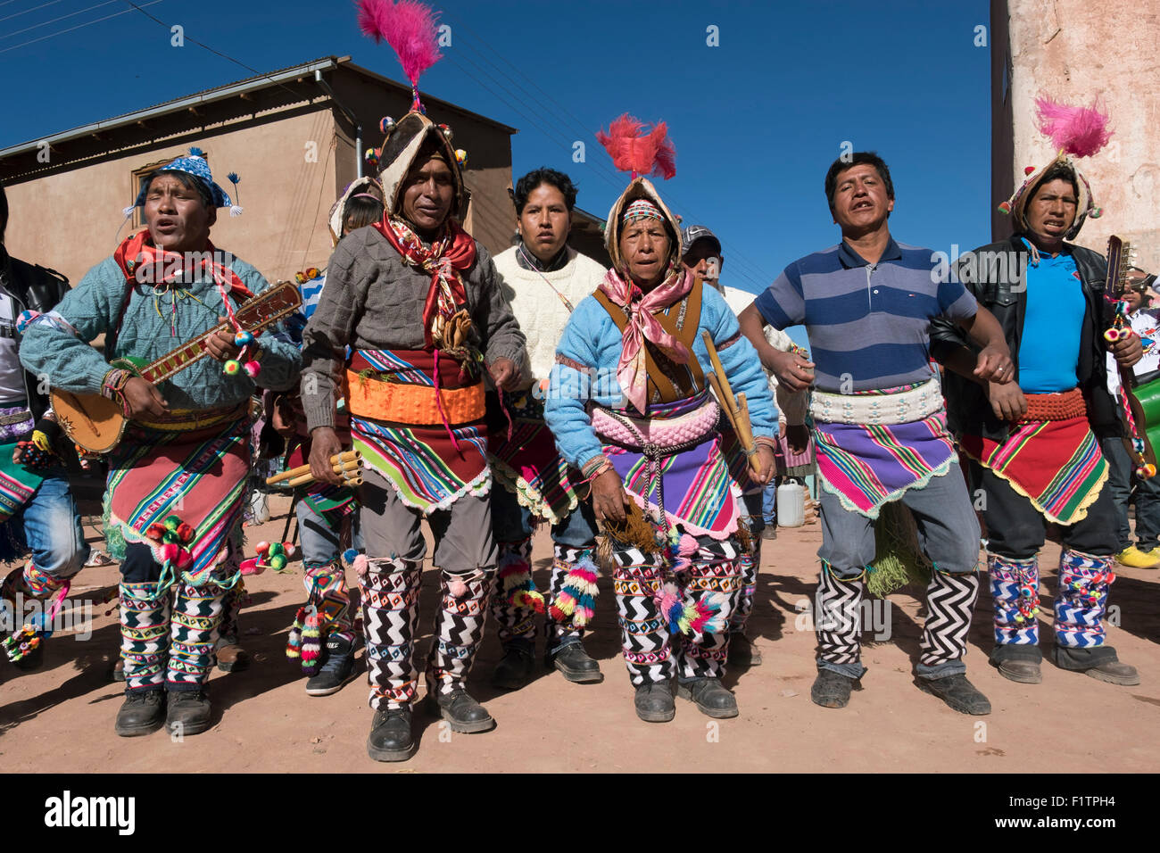 Groups of men dance and play their traditional Andean instruments Stock ...