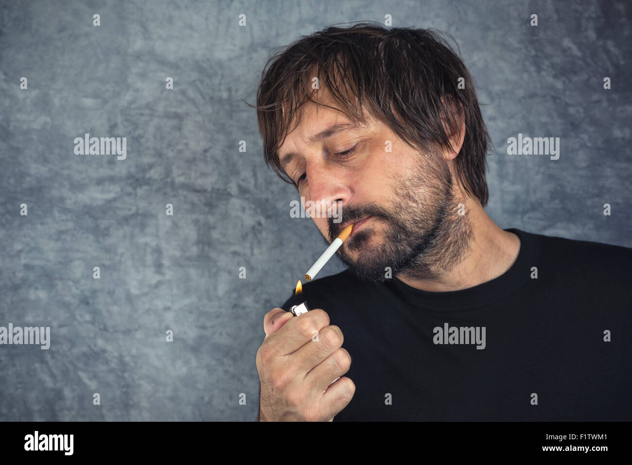 Man lighting cigarette hi-res stock photography and images - Alamy
