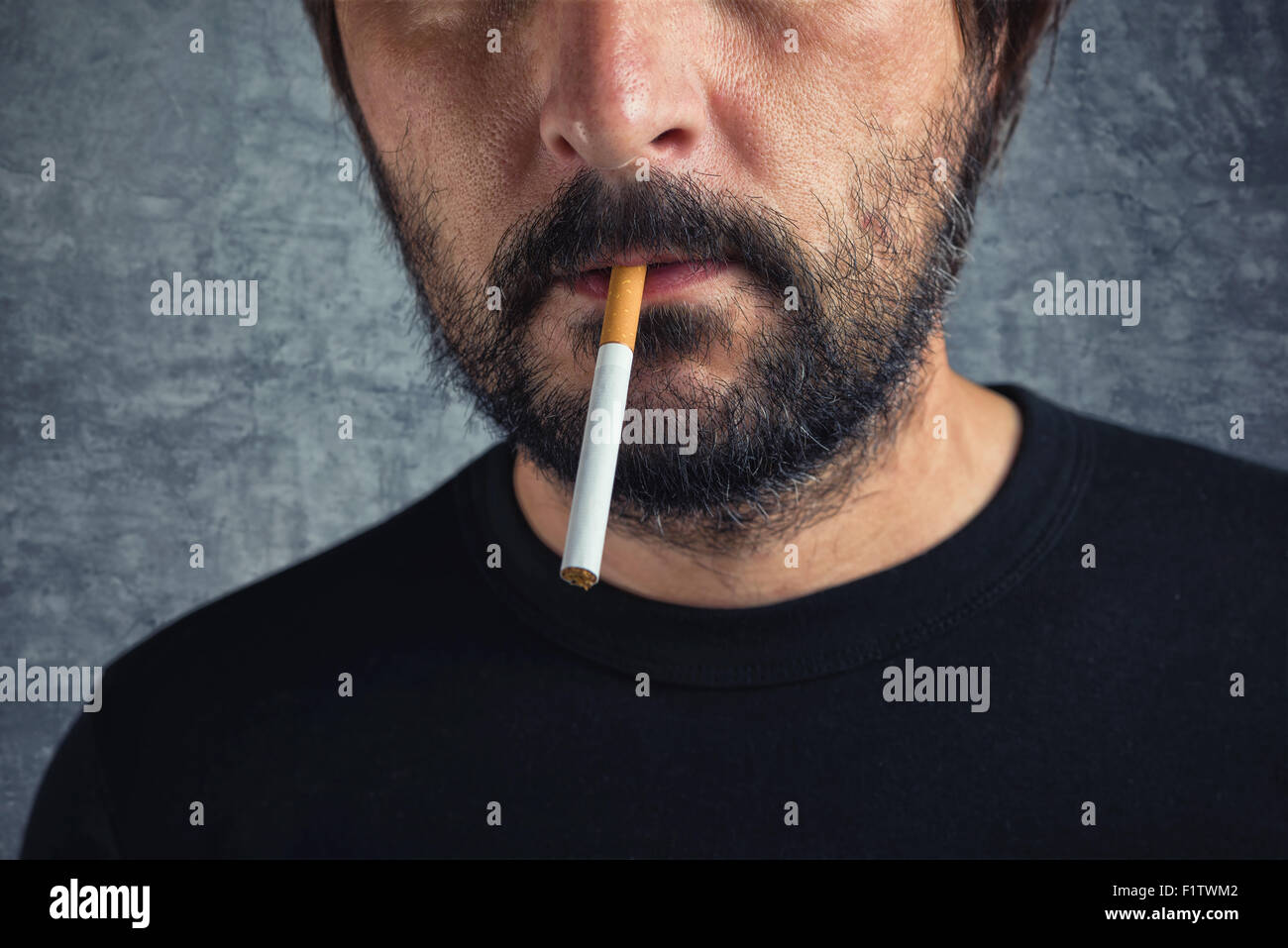Casual adult man with cigarette in mouth Stock Photo - Alamy