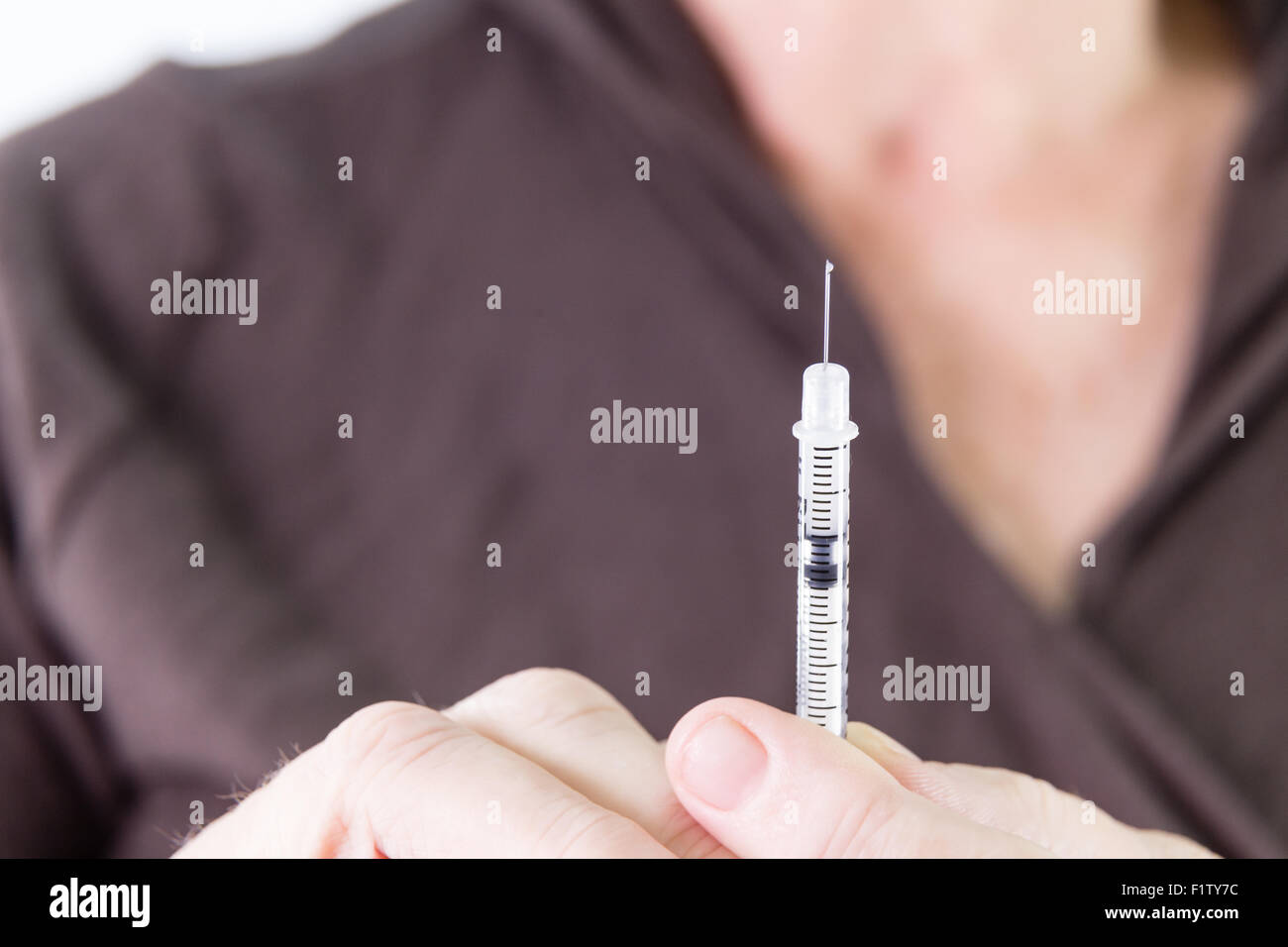Excess insulin squirted out of syringe Stock Photo - Alamy
