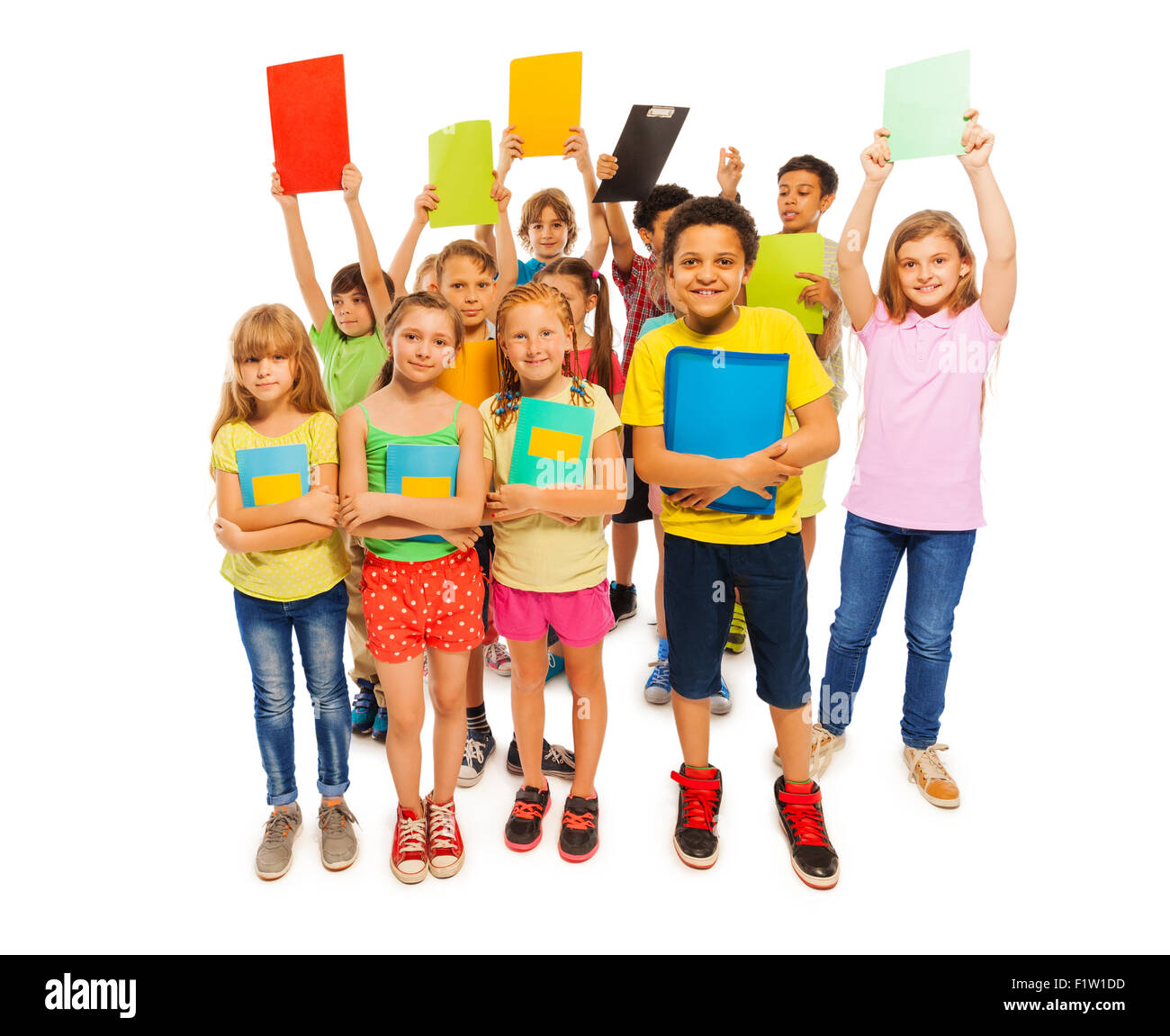 Cool students lifting textbook in the air Stock Photo - Alamy