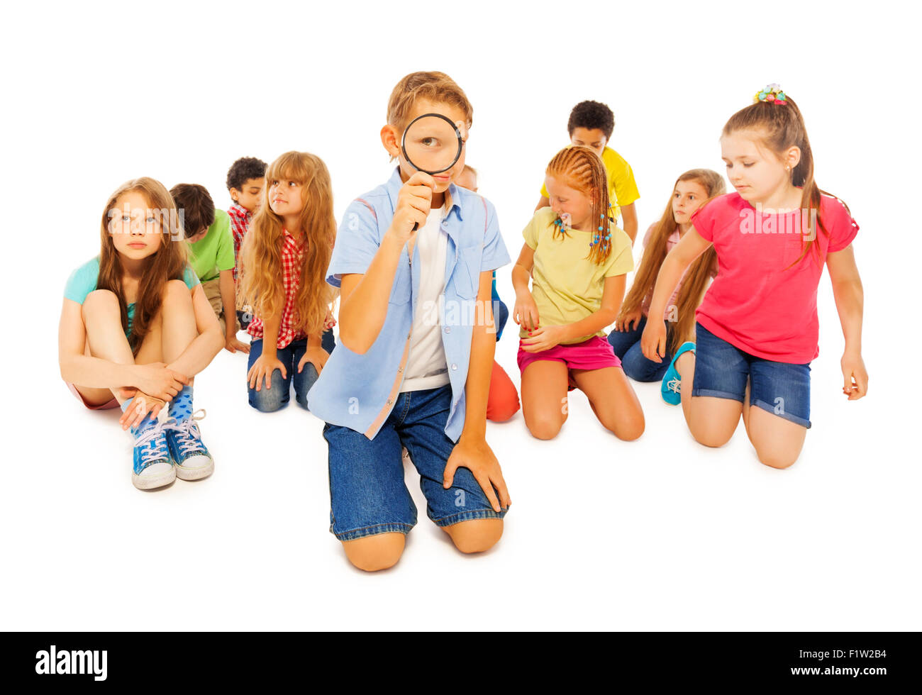 Serious search of school kids with magnifier Stock Photo - Alamy