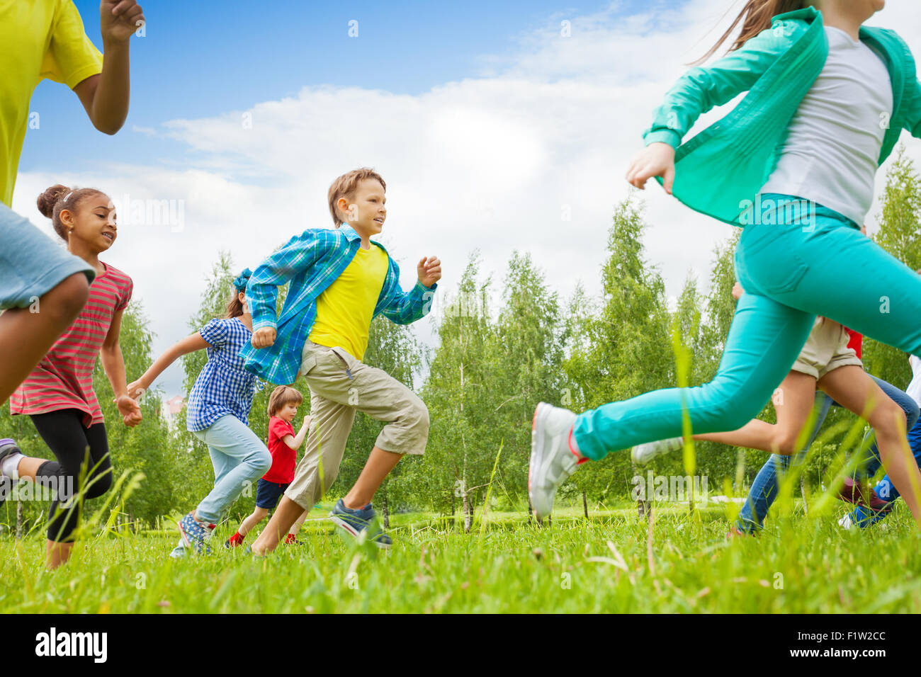 Running children view in the green field Stock Photo - Alamy