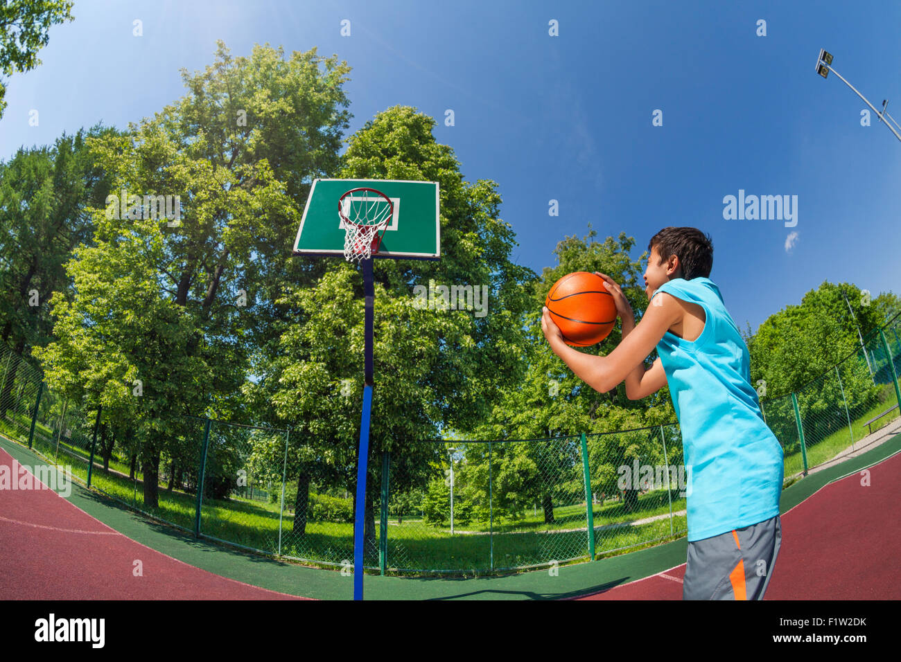 Arabian boy holds ball to throw in basketball goal Stock Photo - Alamy