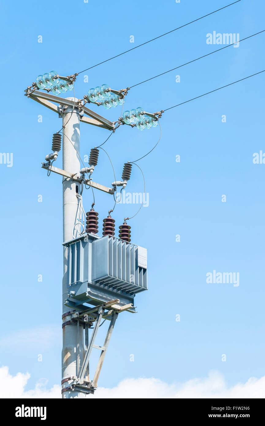 Electrical transformer of electrical pylon against the blue sky Stock ...
