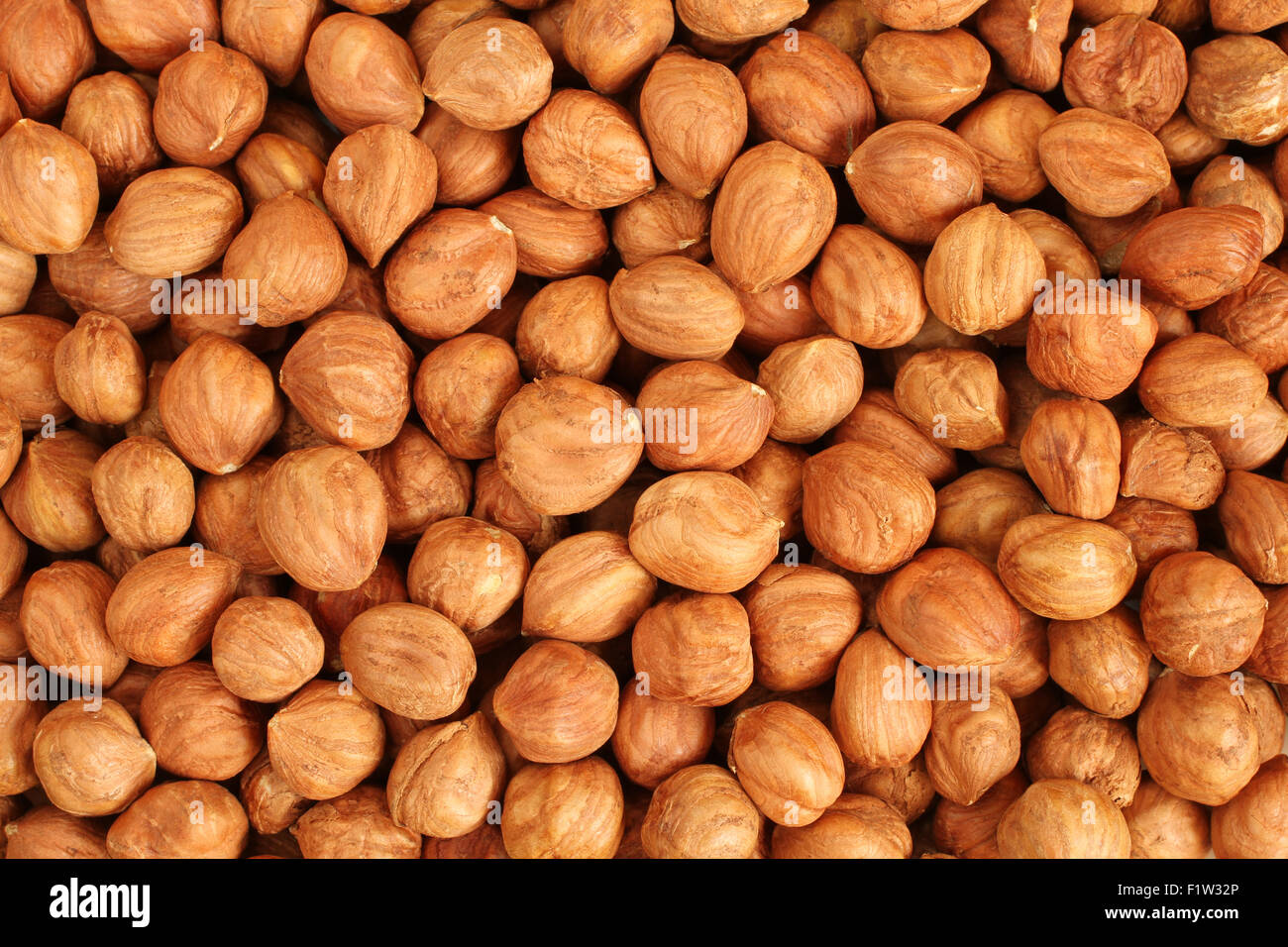Hazelnut Background. Heap of peeled hazelnuts Stock Photo - Alamy