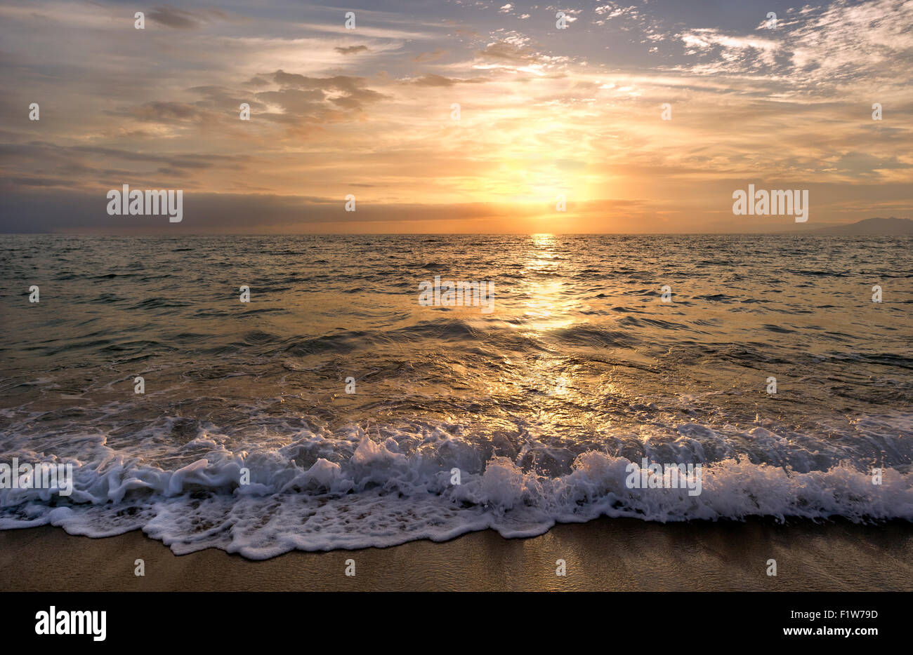 Ocean Sunset is the sun setting on the ocean horizon with a soft surf ...