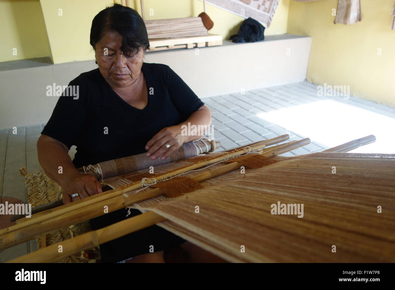 A Peruvian lady uses her hand loom to weave elaborate traditional ...