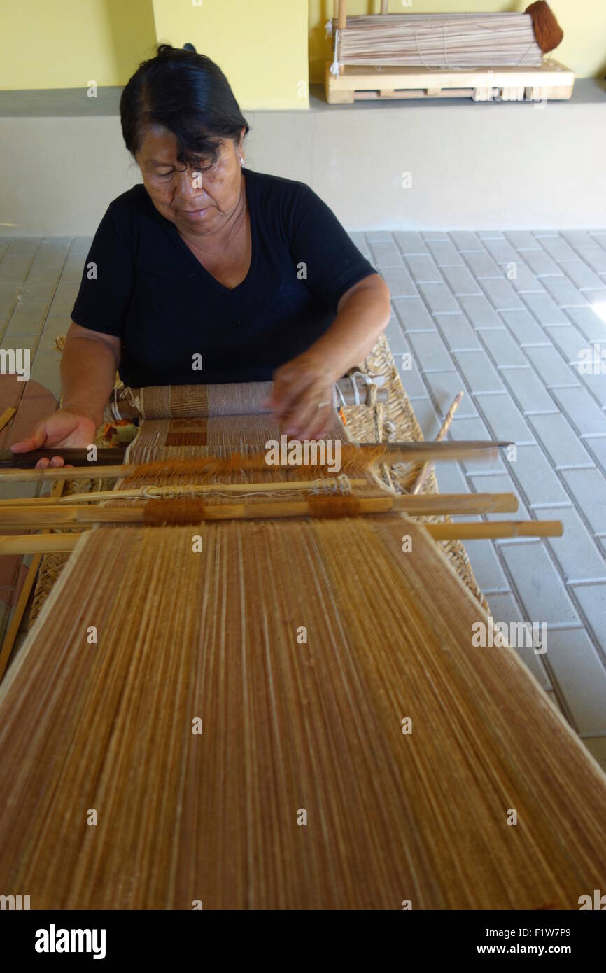 A Peruvian lady uses her hand loom to weave elaborate traditional ...