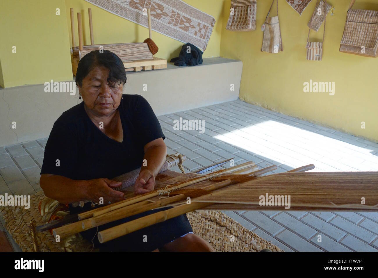 A Peruvian lady uses her hand loom to weave elaborate traditional ...