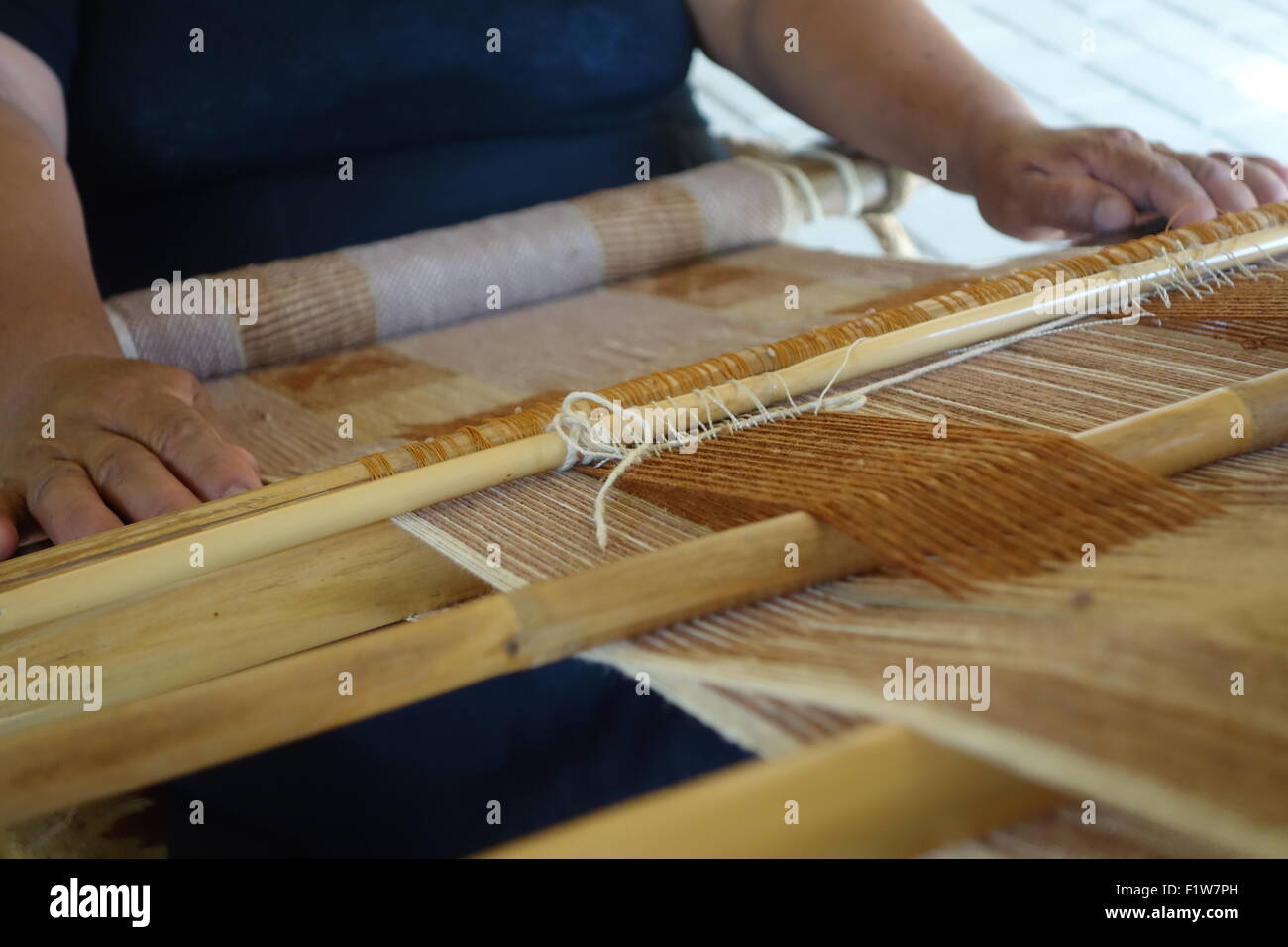 A Peruvian lady uses her hand loom to weave elaborate traditional ...