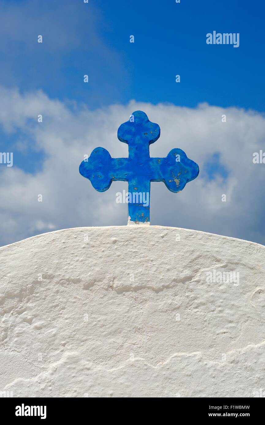 A blue holy cross on top of a whitewashed church on the island of ...
