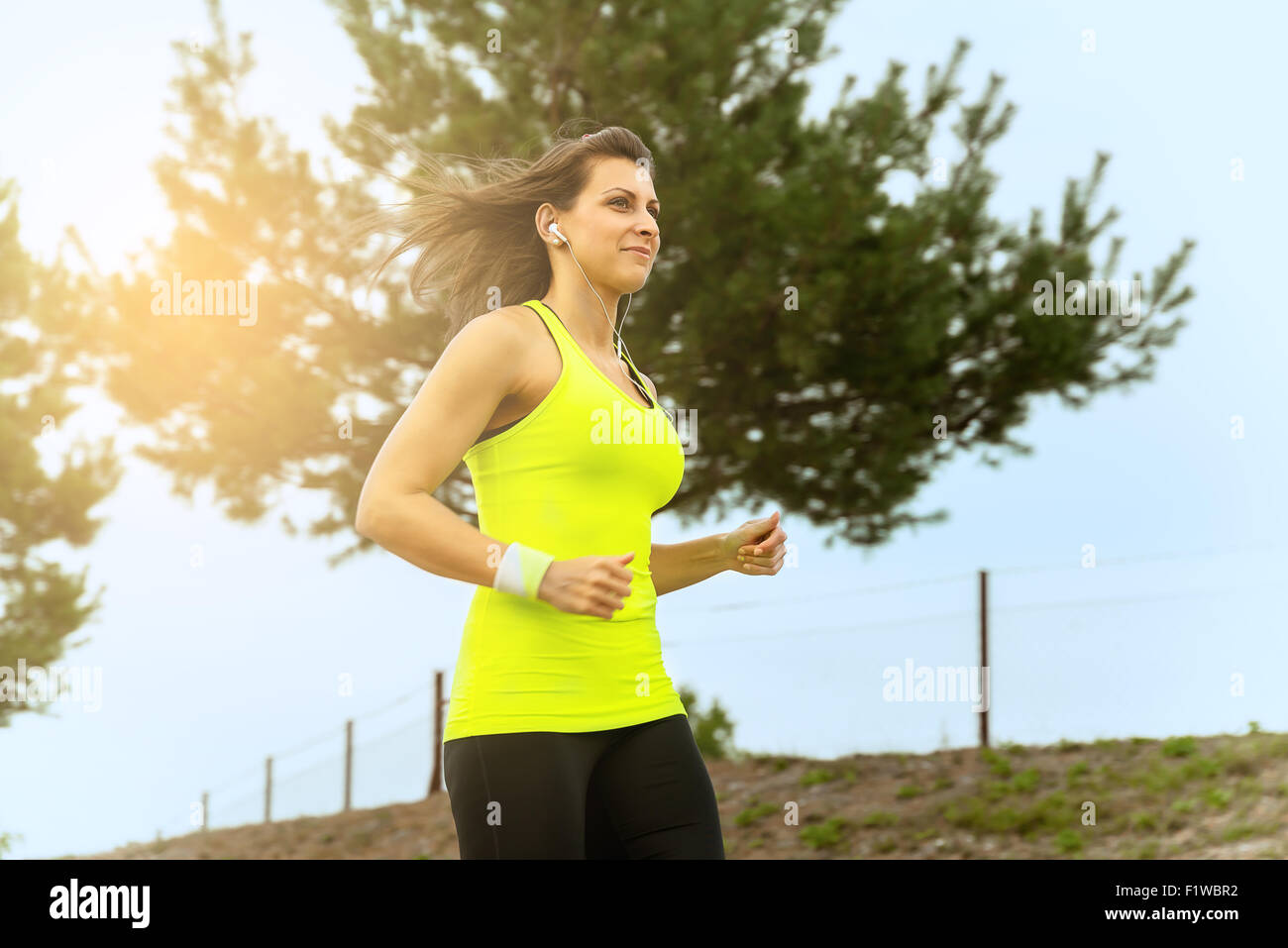 Running woman in a park at sunset Stock Photo - Alamy