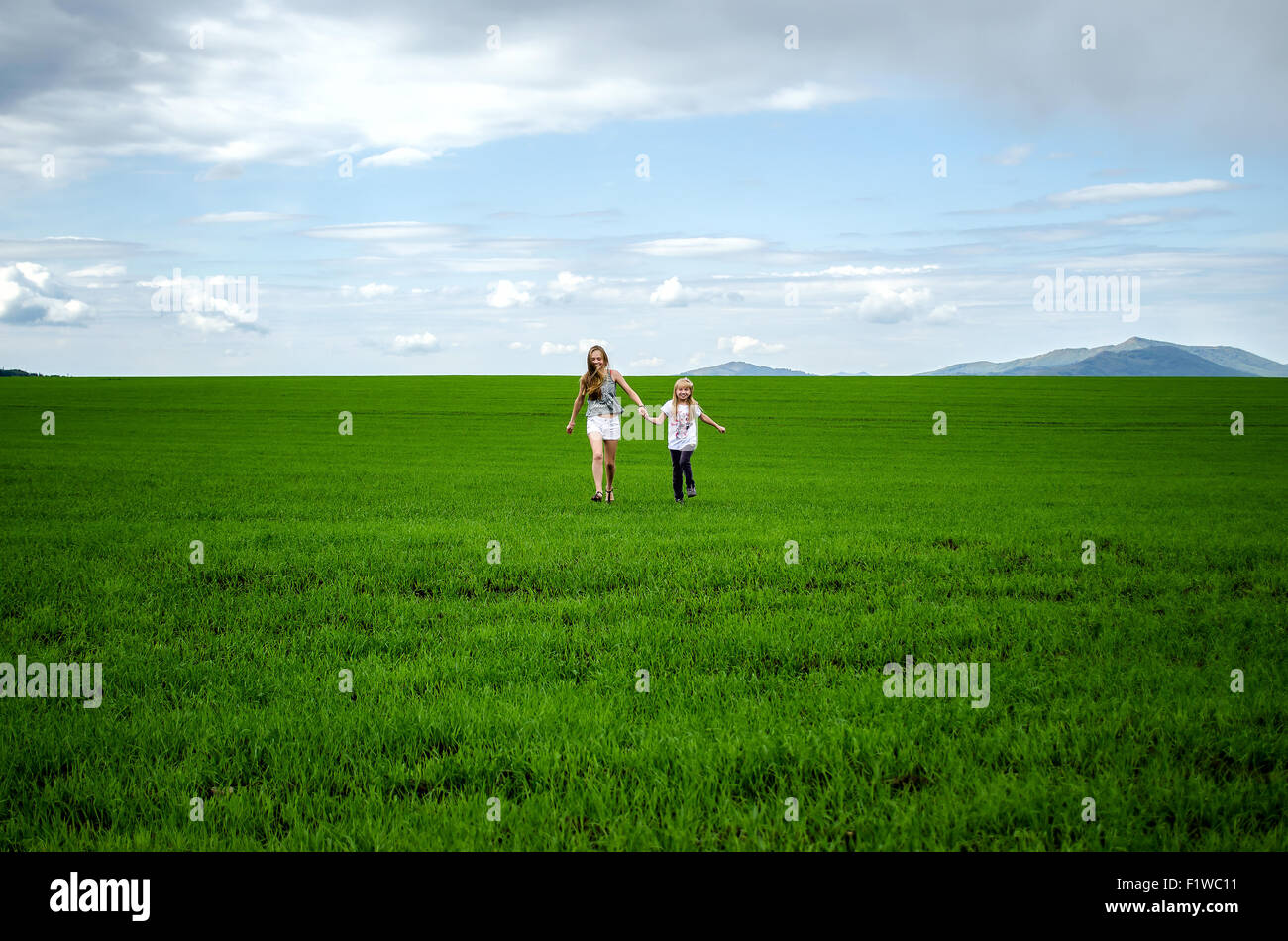 girls ran across the field Stock Photo - Alamy