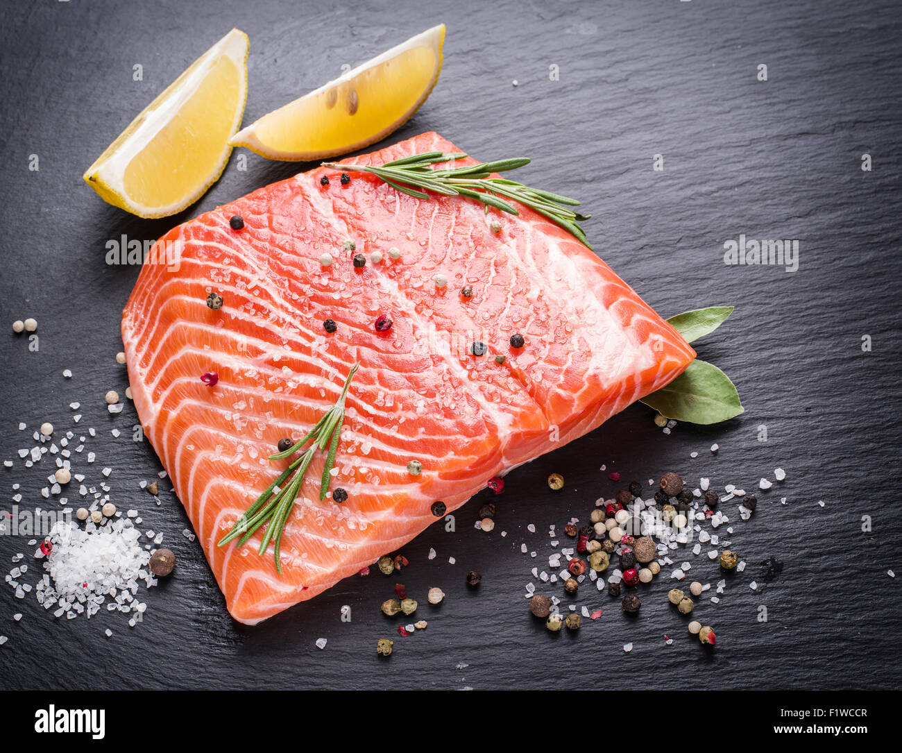 Fresh salmon on the black cutting board Stock Photo - Alamy