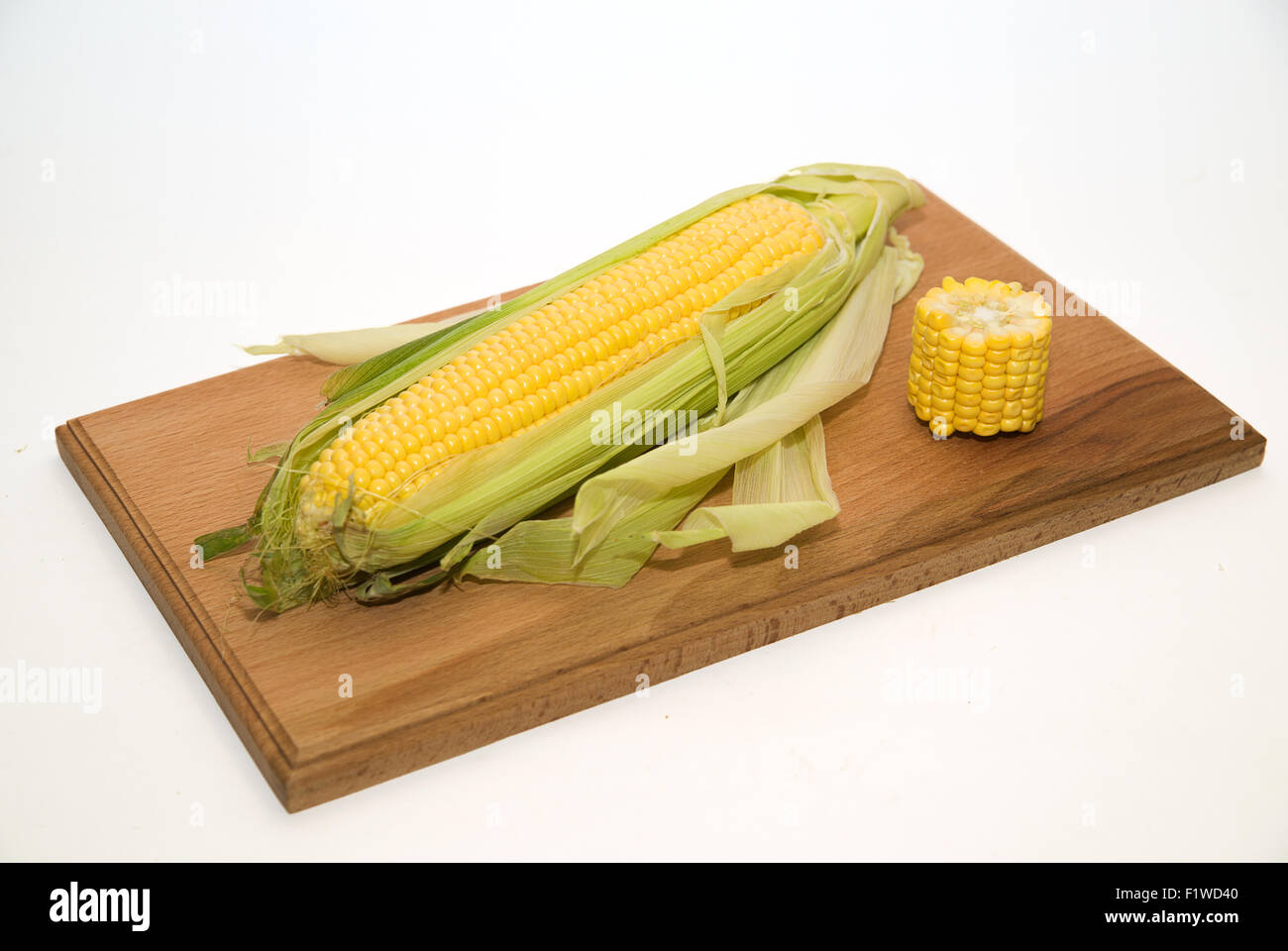 A ripe fruit of corn on a wooden surface Stock Photo - Alamy
