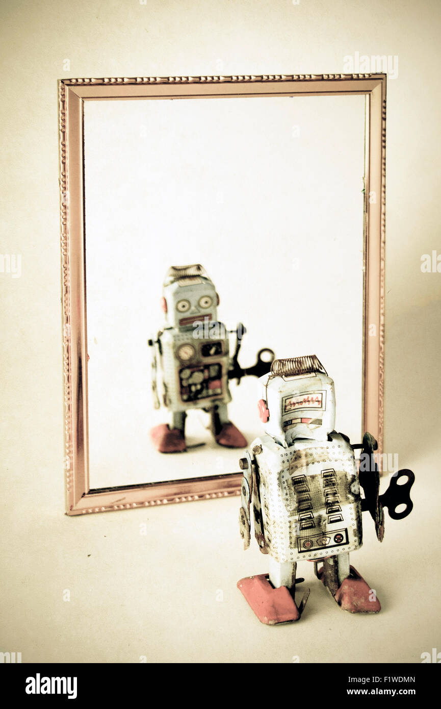 sad robot looking on the mirror Stock Photo - Alamy