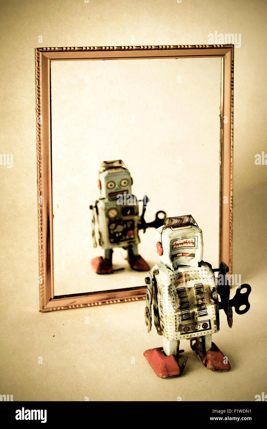 sad robot looking on the mirror Stock Photo - Alamy