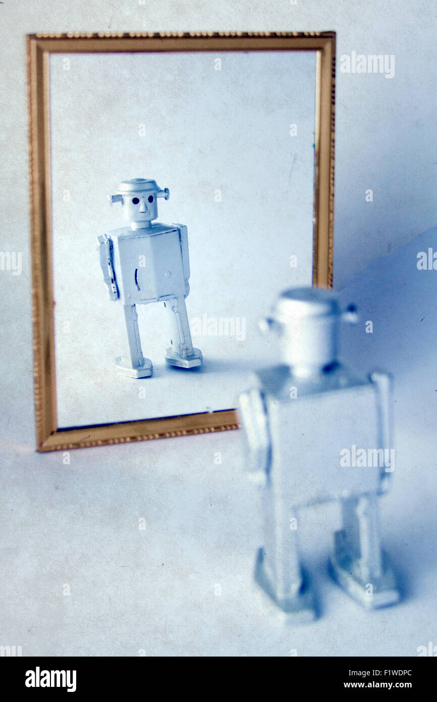 sad robot looking on the mirror Stock Photo - Alamy
