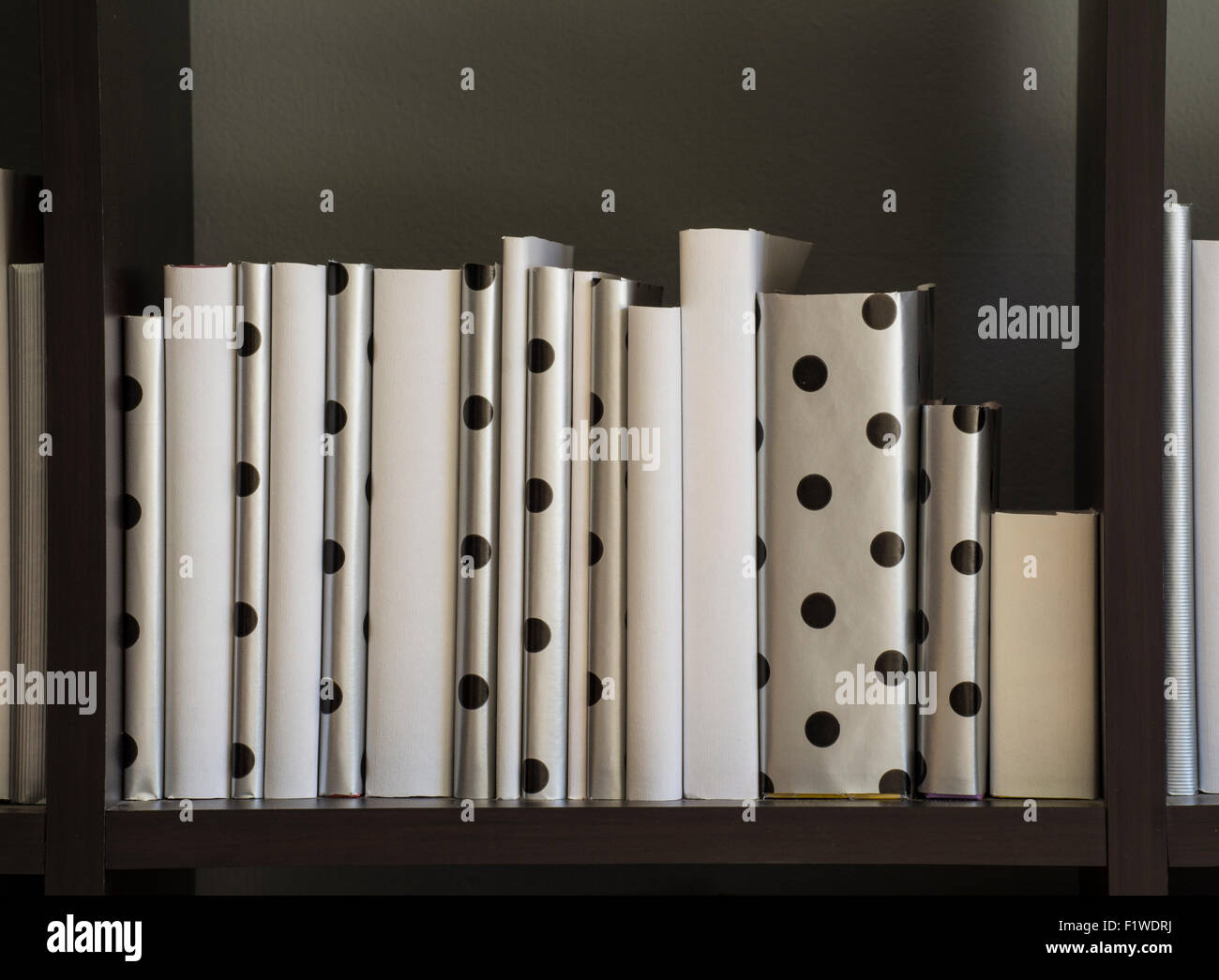 Covered books on a bookshelf Stock Photo - Alamy