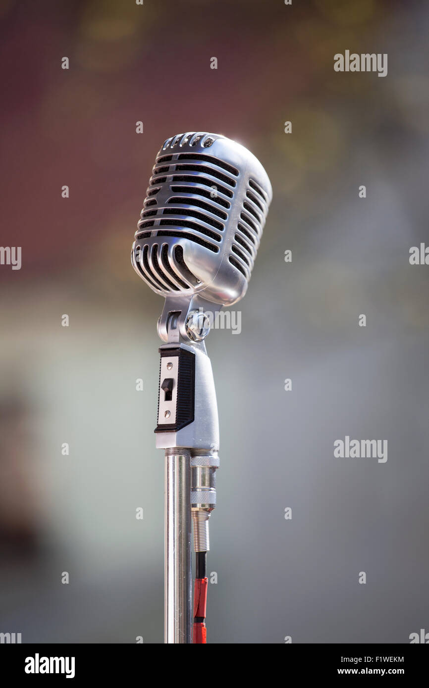 Vintage stage microphone against blurred background Stock Photo - Alamy