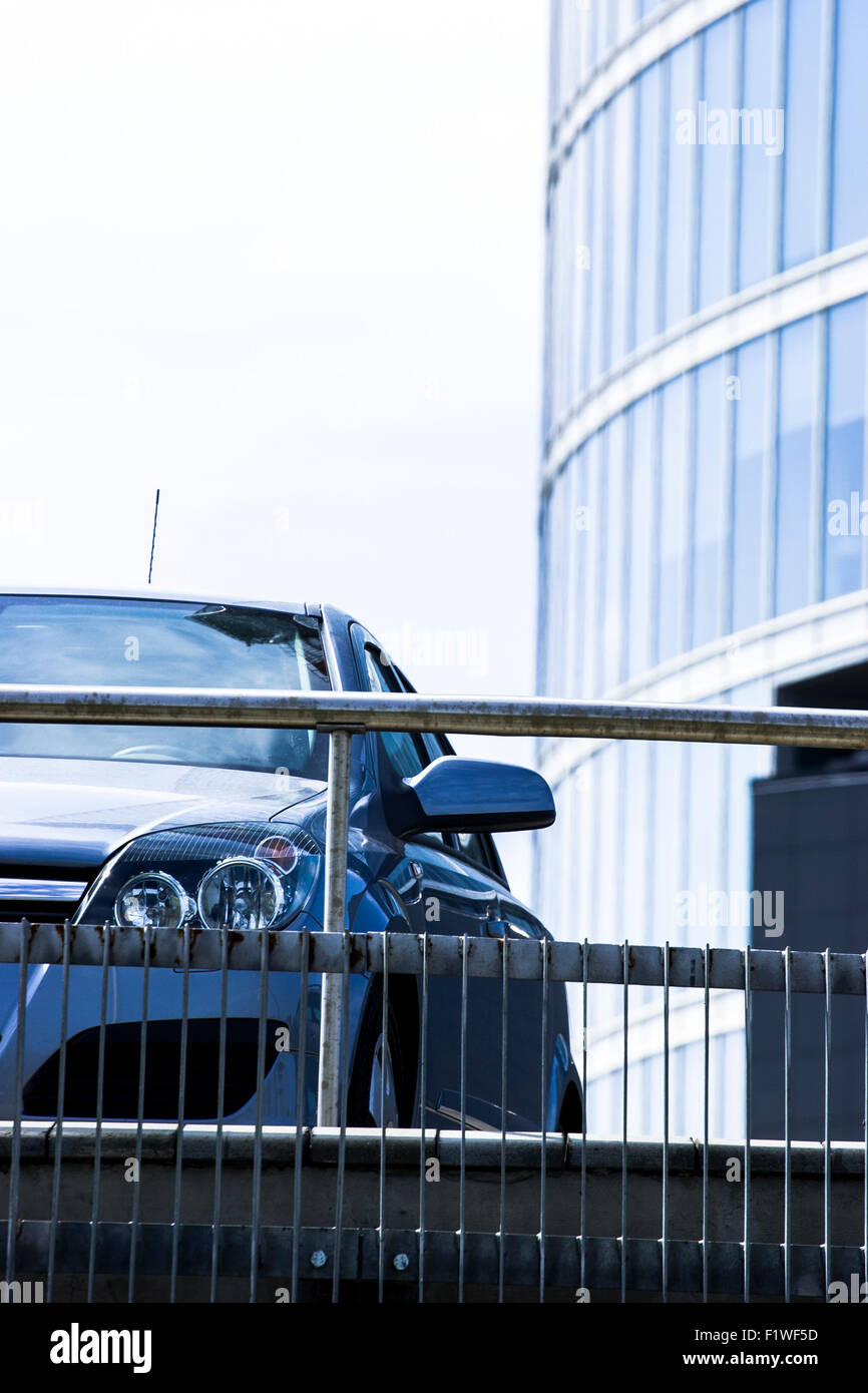Front view of car in parking place with skyscraper in background Stock ...