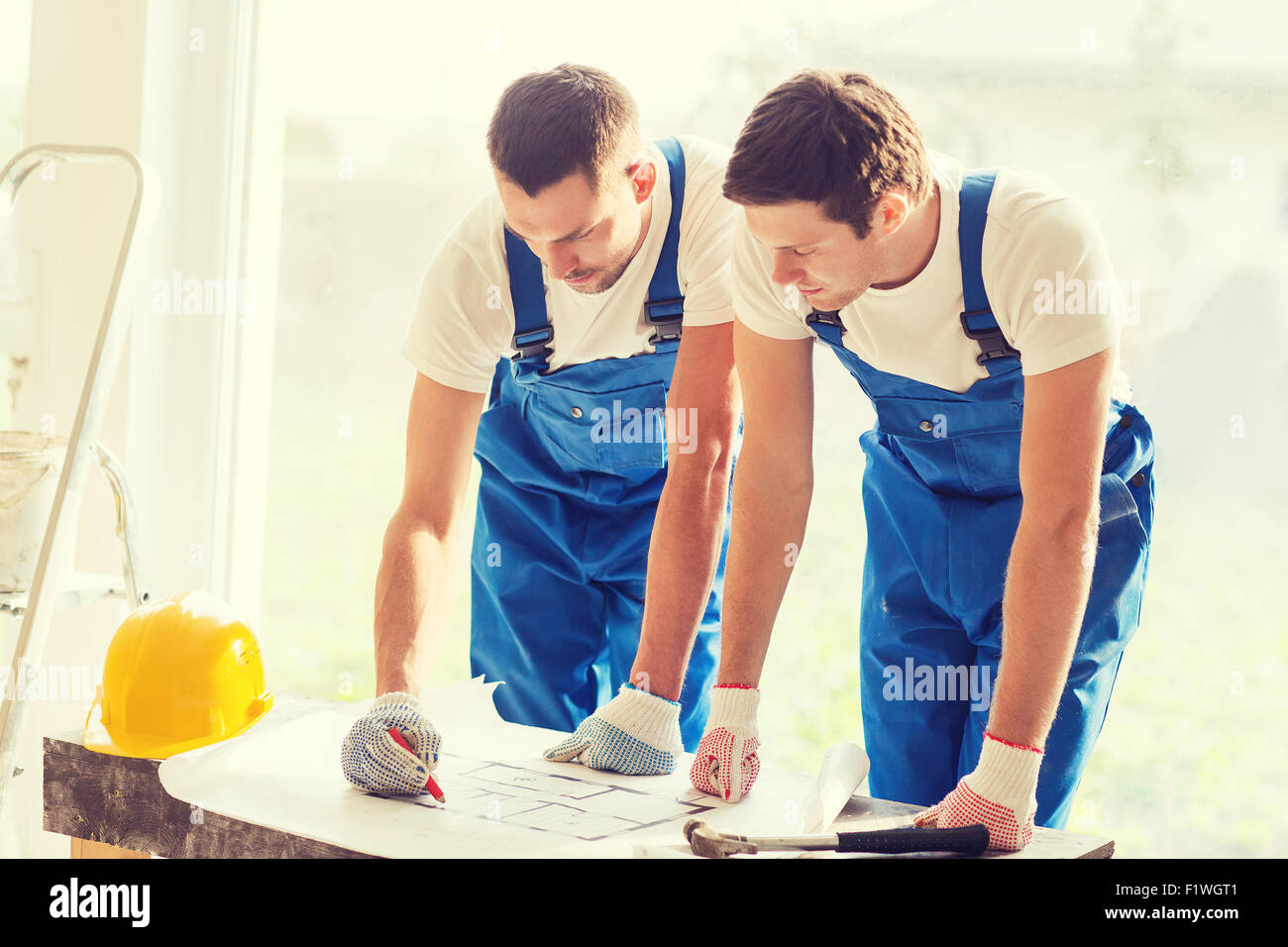 group of builders with blueprint Stock Photo - Alamy