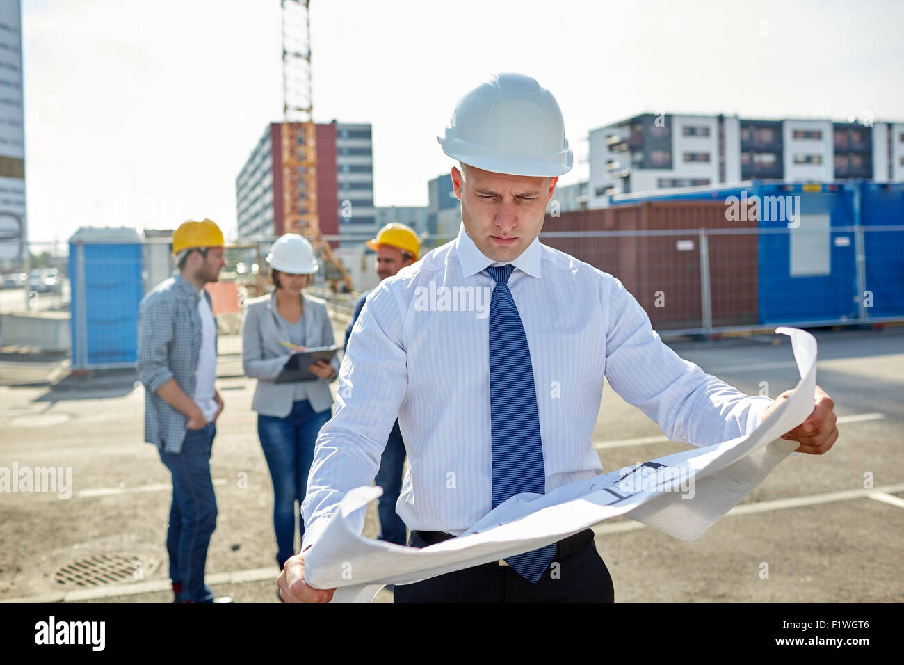 architect with blueprint on construction site Stock Photo - Alamy