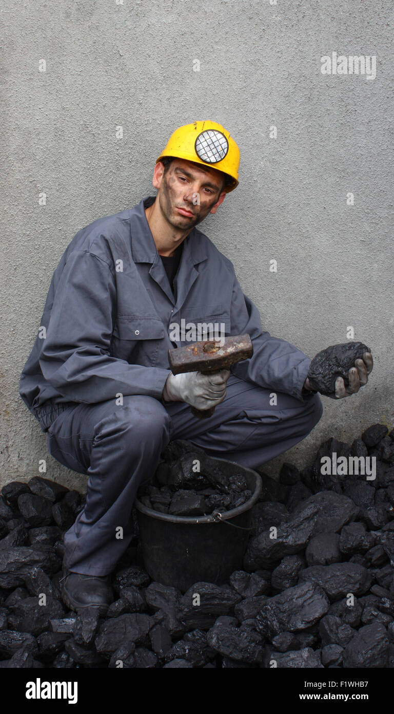 Miner hammer smashing a stone coal Stock Photo - Alamy