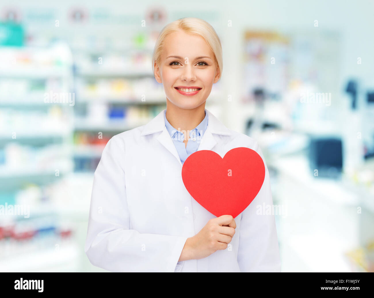 woman pharmacist with heart at drugstore Stock Photo - Alamy