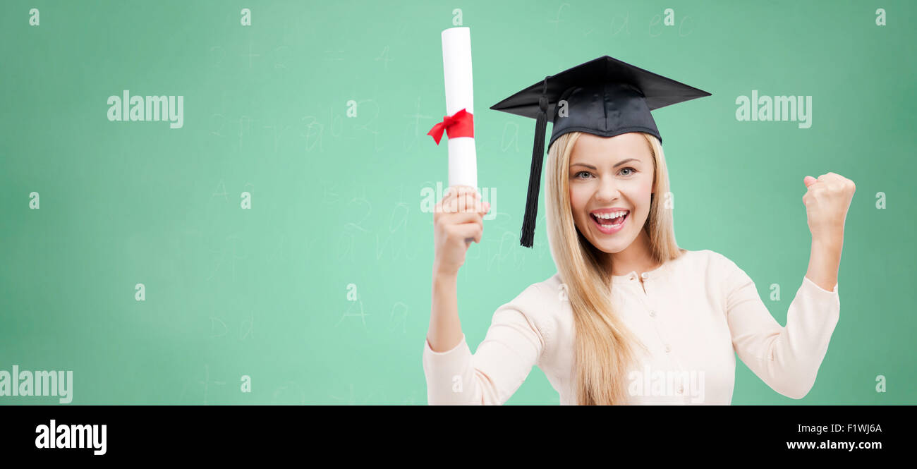 student in trencher cap with diploma over green Stock Photo - Alamy