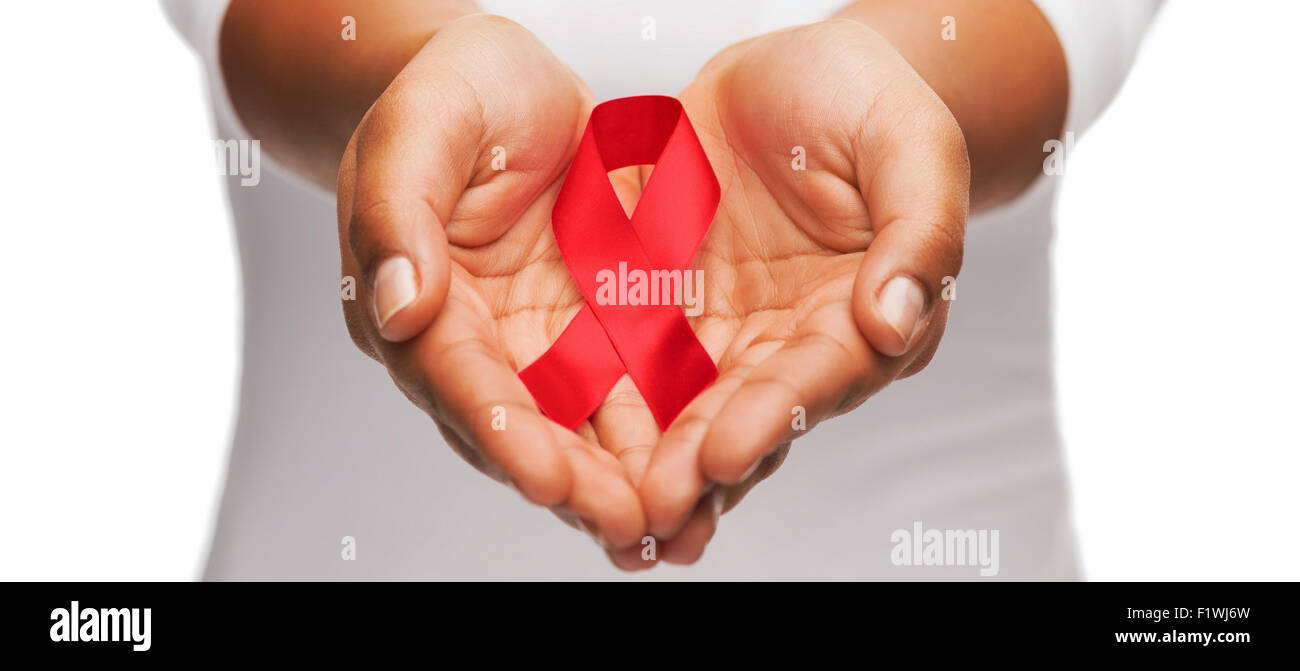 hands holding red AIDS awareness ribbon Stock Photo - Alamy