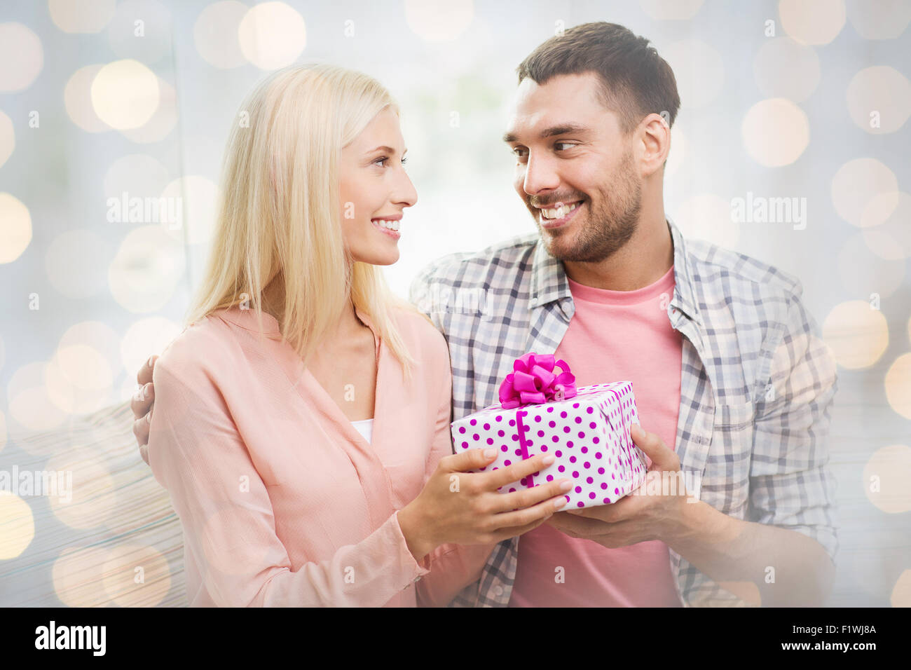 Happy woman receiving gift hi-res stock photography and images - Alamy