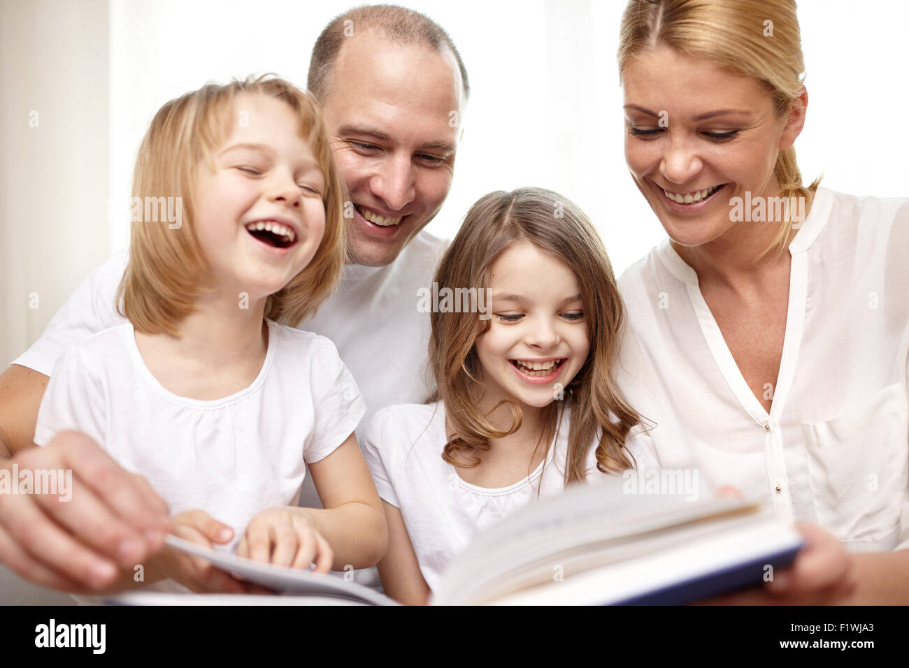 happy family reading book at home Stock Photo - Alamy