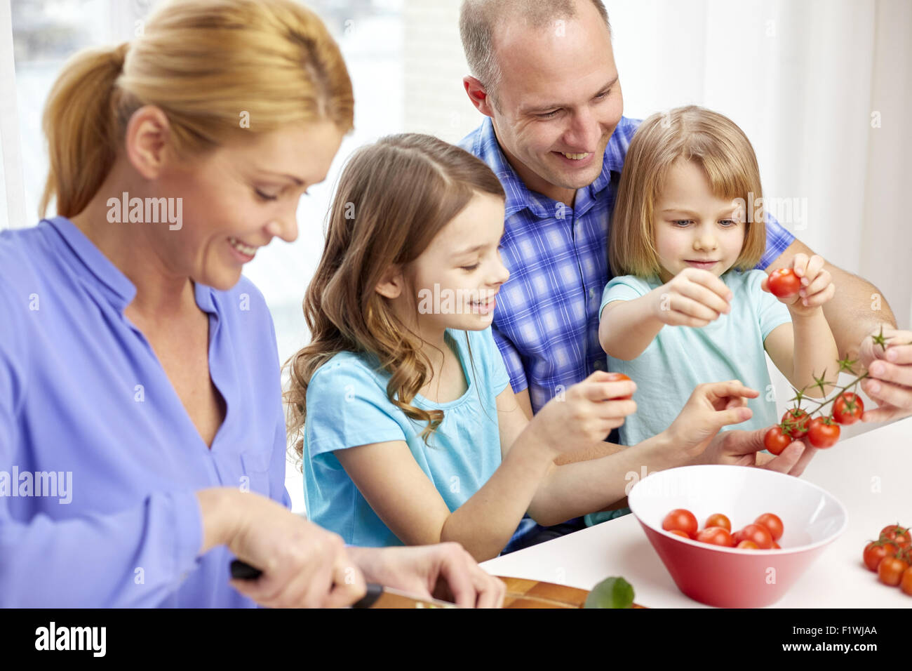 happy family with two kids cooking at home Stock Photo - Alamy