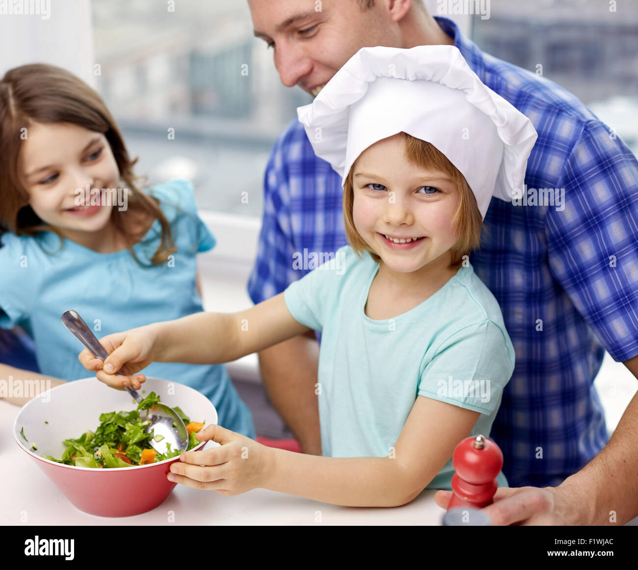 happy family with two kids cooking at home Stock Photo - Alamy