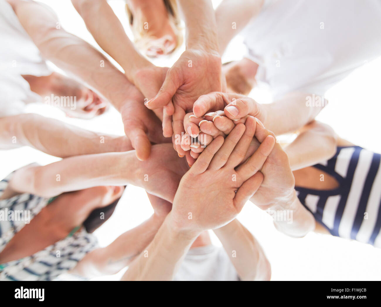 close up of friends with hands on top Stock Photo - Alamy