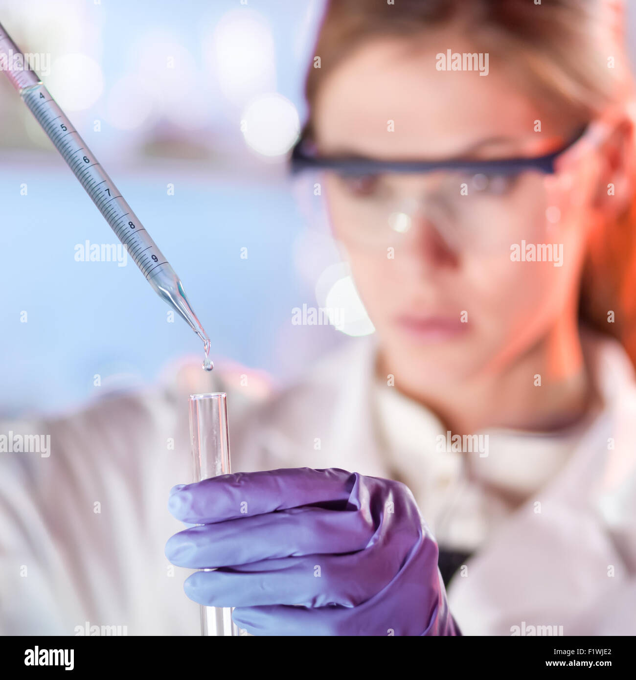 Young scientist pipetting in life science laboratory Stock Photo - Alamy