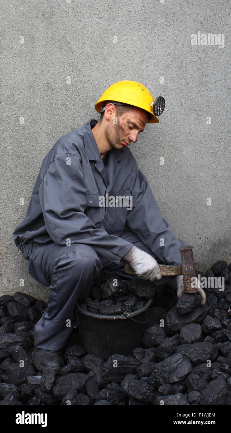 Miner hammer smashing a stone coal Stock Photo - Alamy